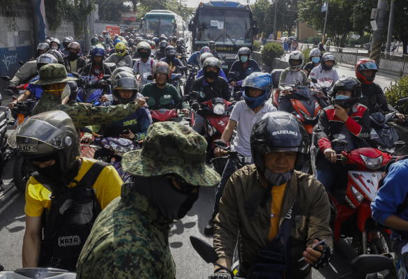 Motorcycle riders coming from Rizal province stop for verification at a ...
